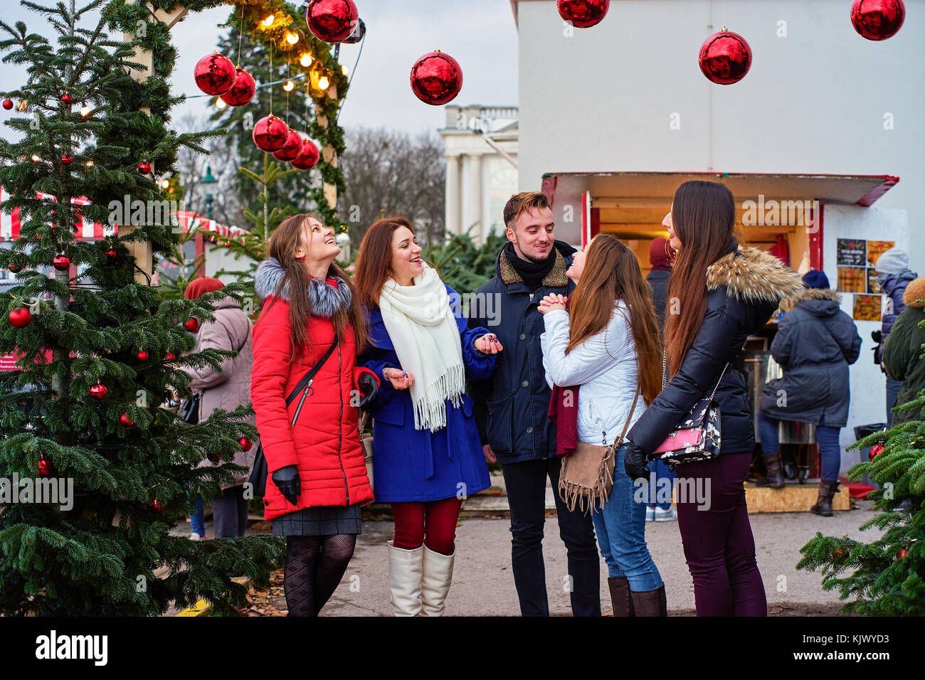 Five young people spending time at Christmas market Stock Photo - Alamy