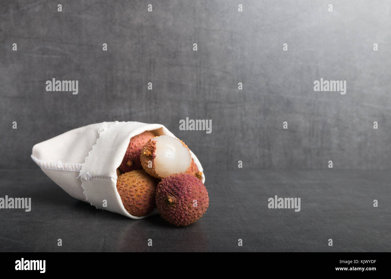 lychee fruit on a grey stone background Stock Photo - Alamy