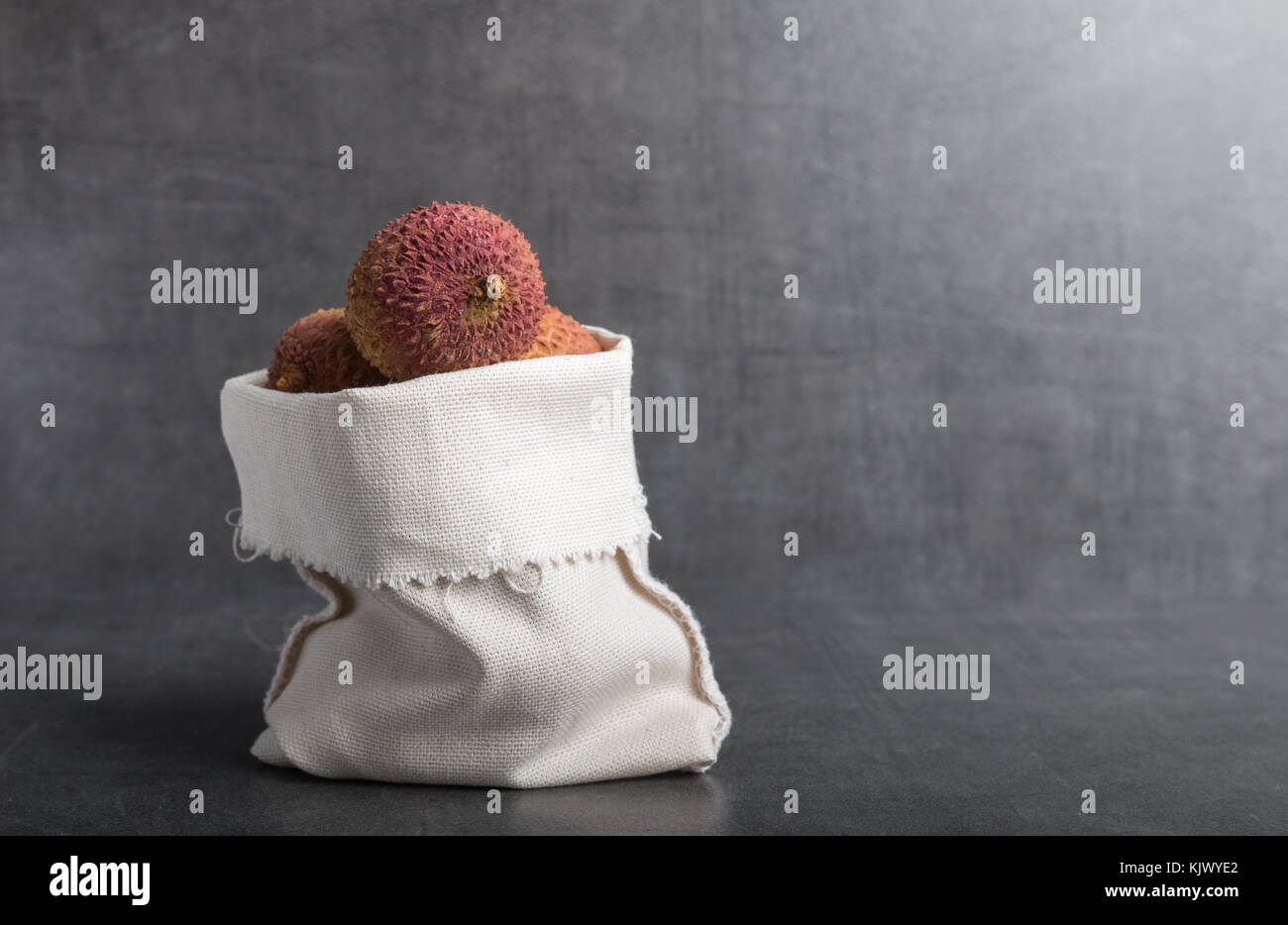 lychee fruit on a grey stone background Stock Photo - Alamy