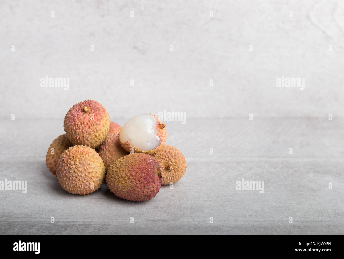 lychee fruit on a grey stone background Stock Photo - Alamy