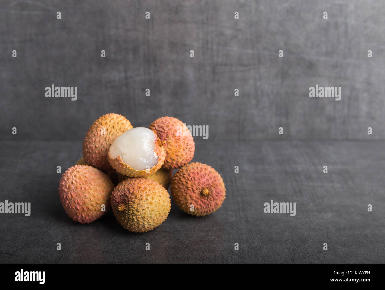 lychee fruit on a grey stone background Stock Photo - Alamy