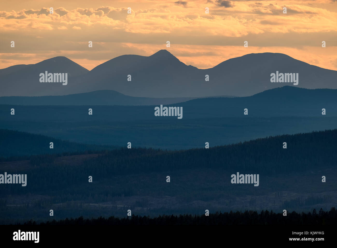 Layered mountains during sunset Stock Photo - Alamy
