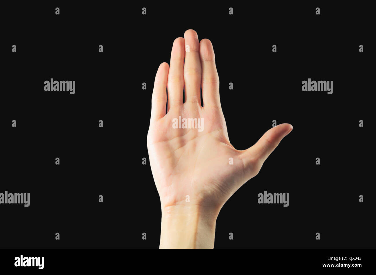 Beautiful female hand isolated on black background, asian, yellow skin ...