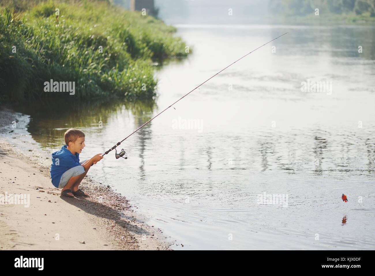 Boy holding fishing rod hi-res stock photography and images - Alamy