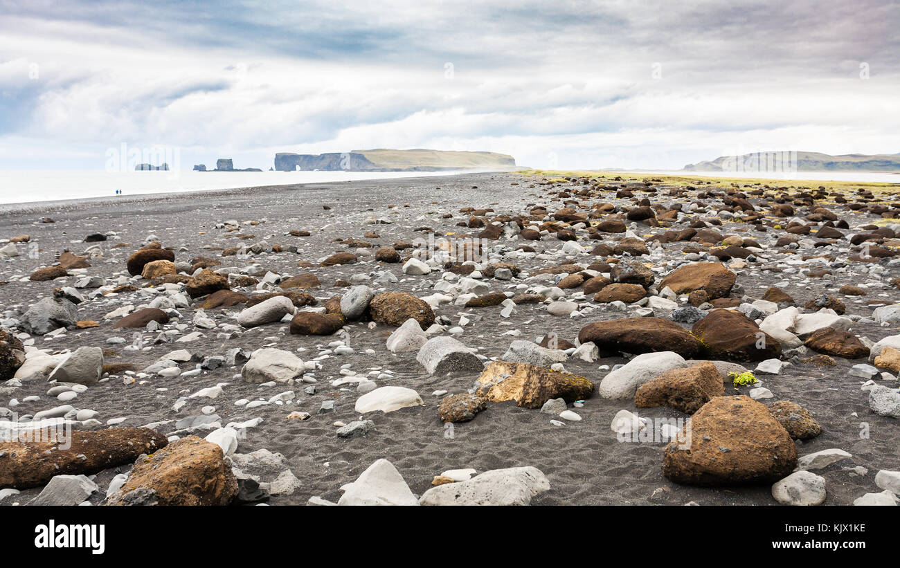 travel to Iceland - surface of Reynisfjara Beach and view of Dyrholaey ...