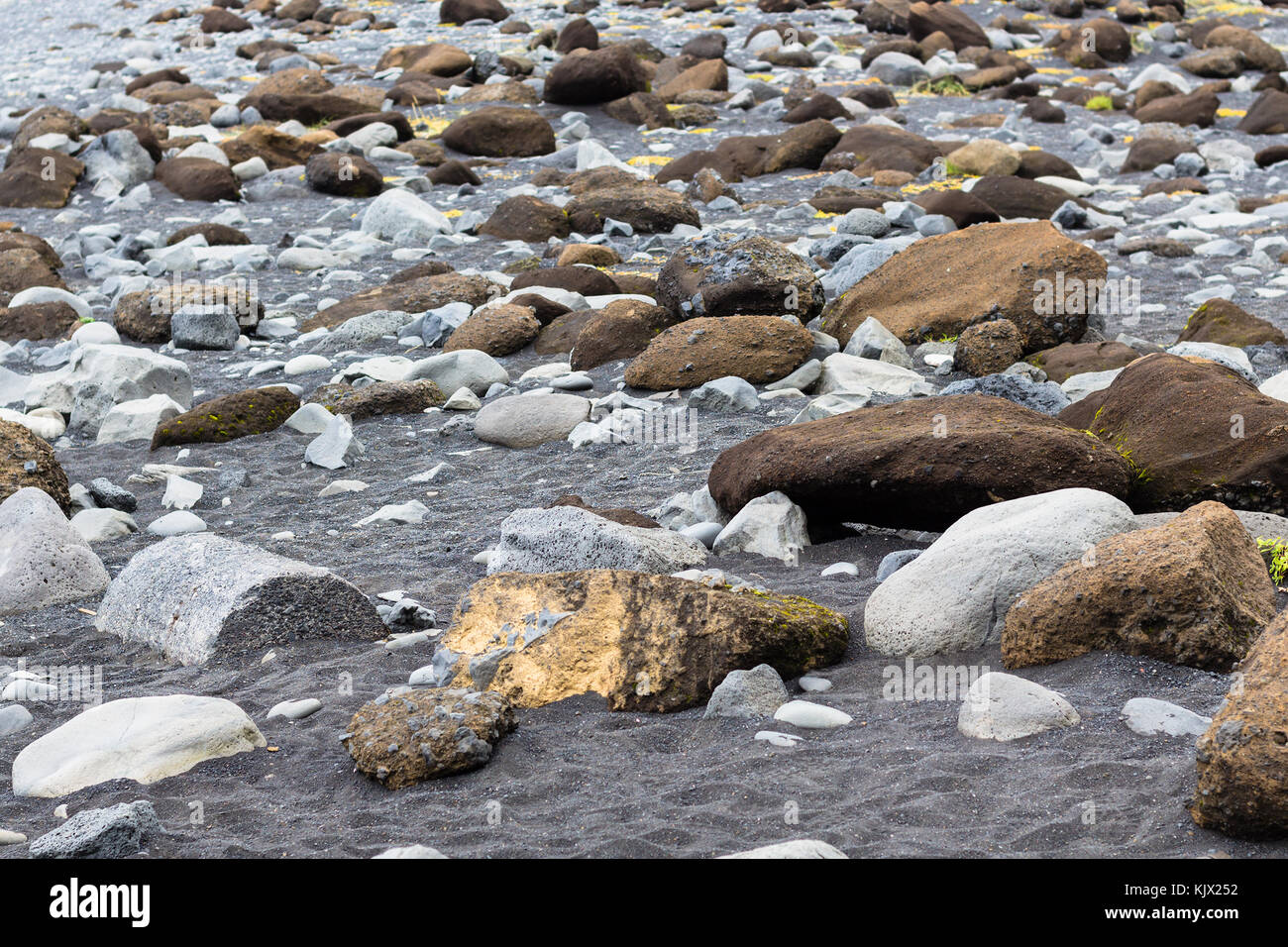 travel to Iceland - boulders on surface of Reynisfjara beach in Iceland ...