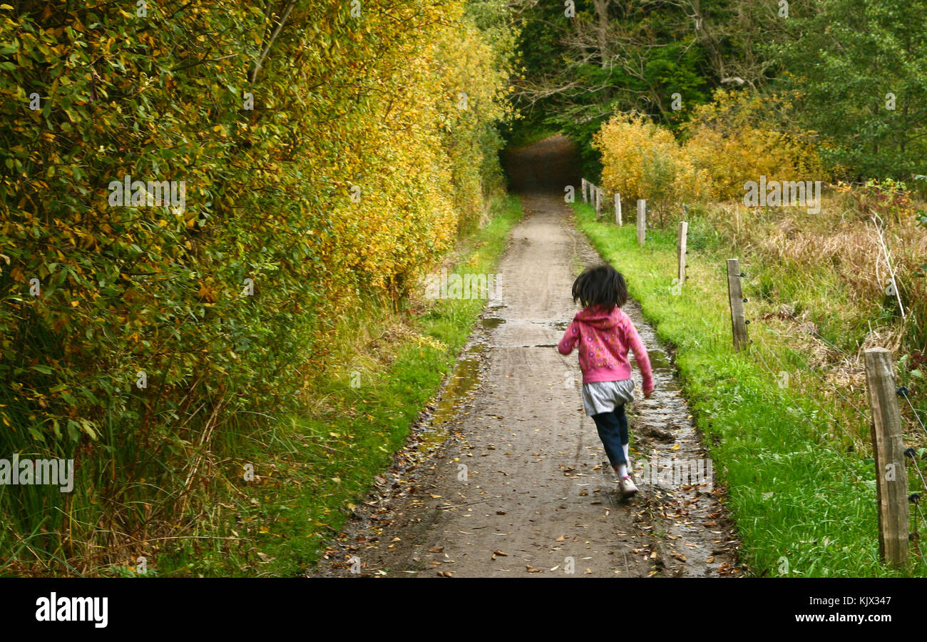 Girl running in a path in the nature Stock Photo - Alamy