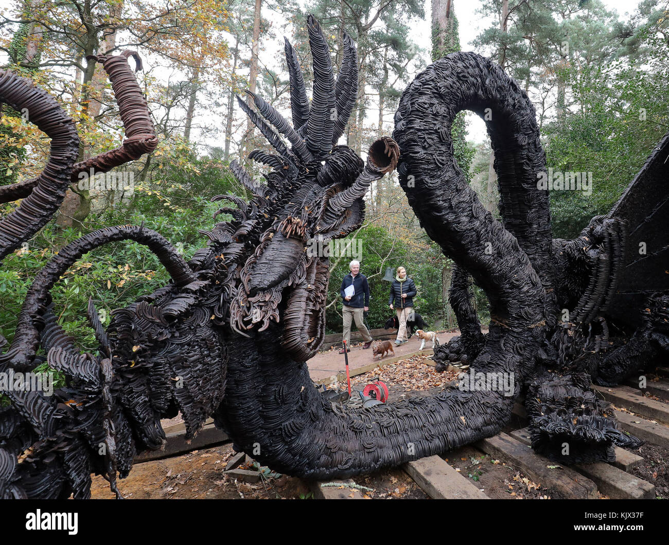 People walk past a dragon sculpture created by artist Jim Poolman from ...