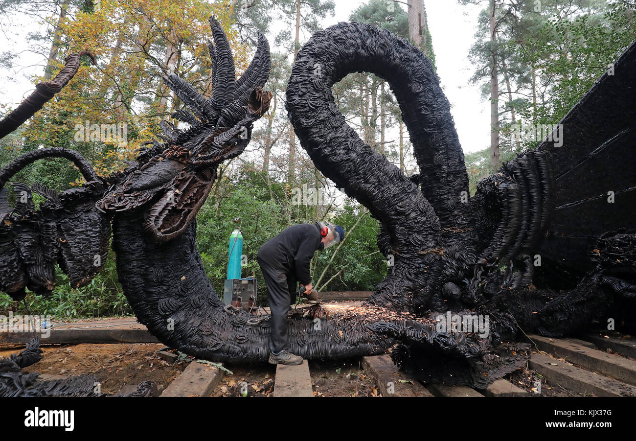 Artist Jim Poolman puts the final touches to a dragon sculpture he has ...