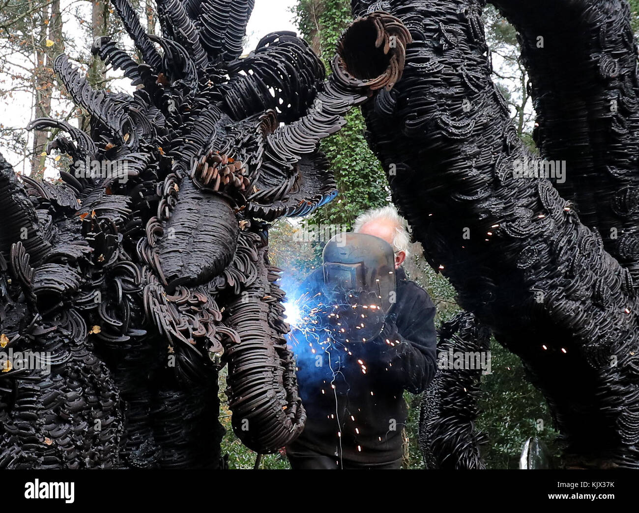 Artist Jim Poolman puts the final touches to a dragon sculpture he has ...