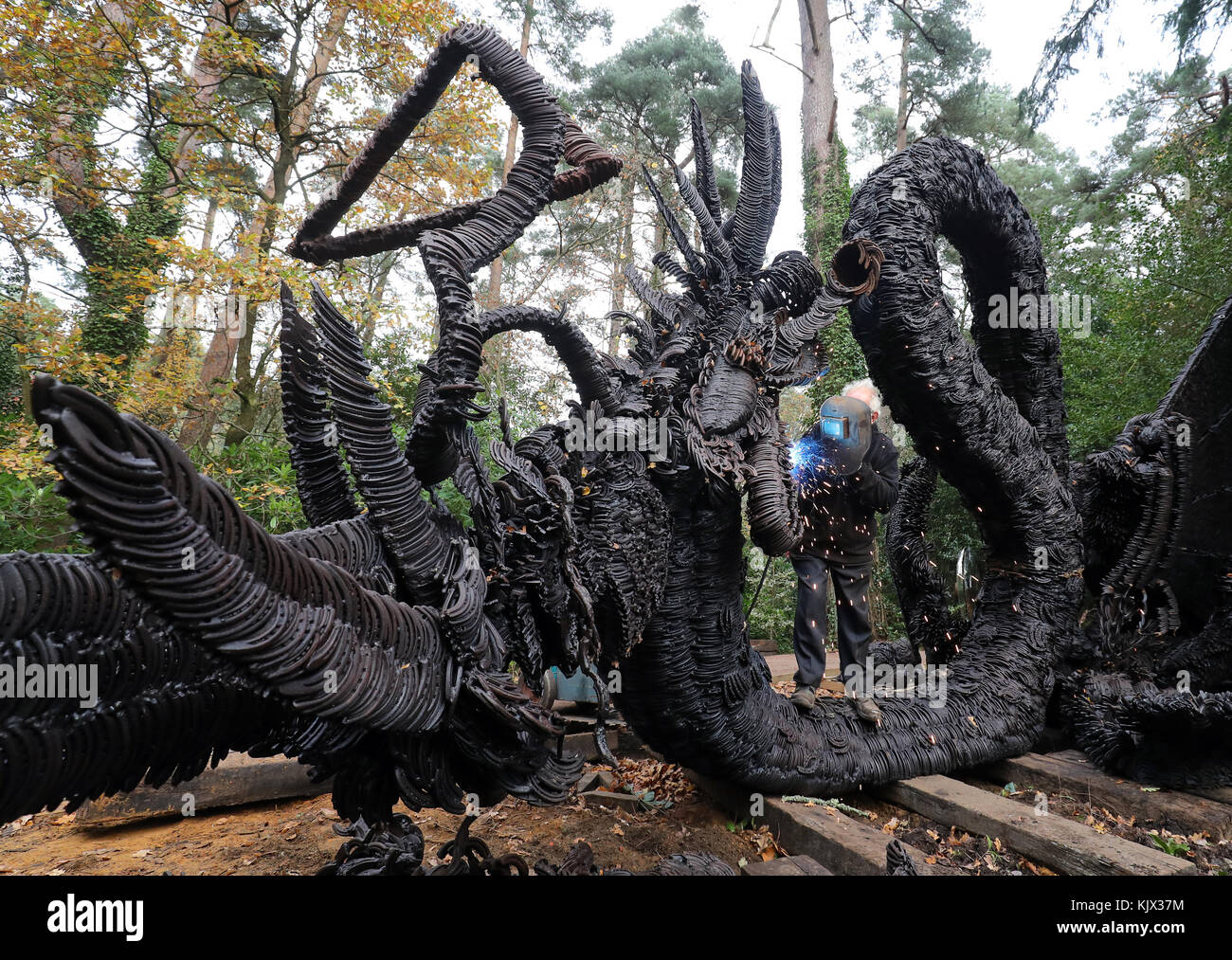 Artist Jim Poolman puts the final touches to a dragon sculpture he has ...