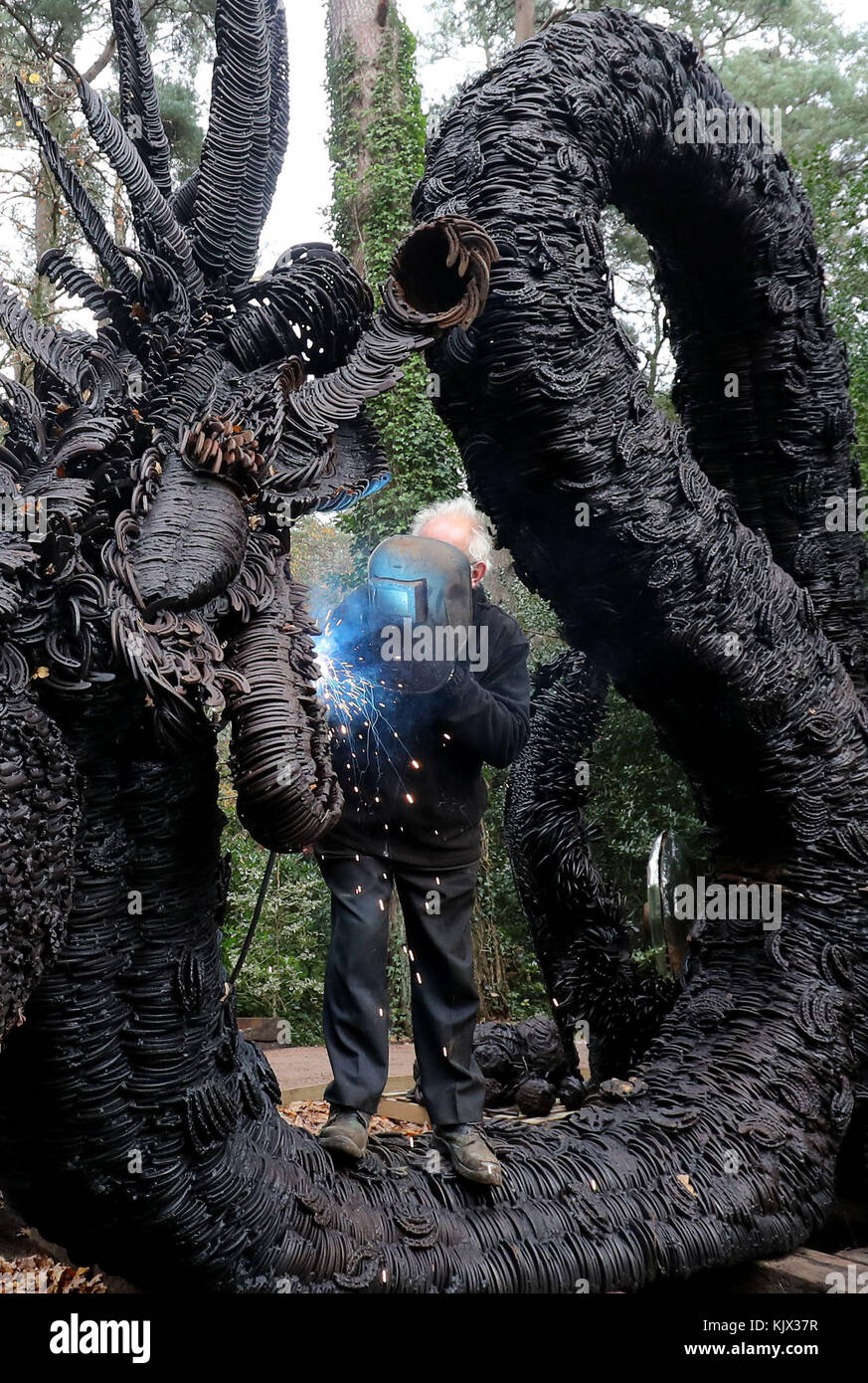 Artist Jim Poolman puts the final touches to a dragon sculpture he has ...