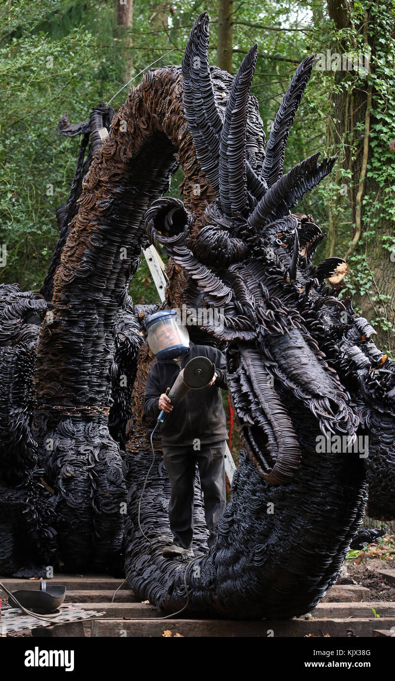 Artist Jim Poolman puts the final touches to a dragon sculpture he has ...