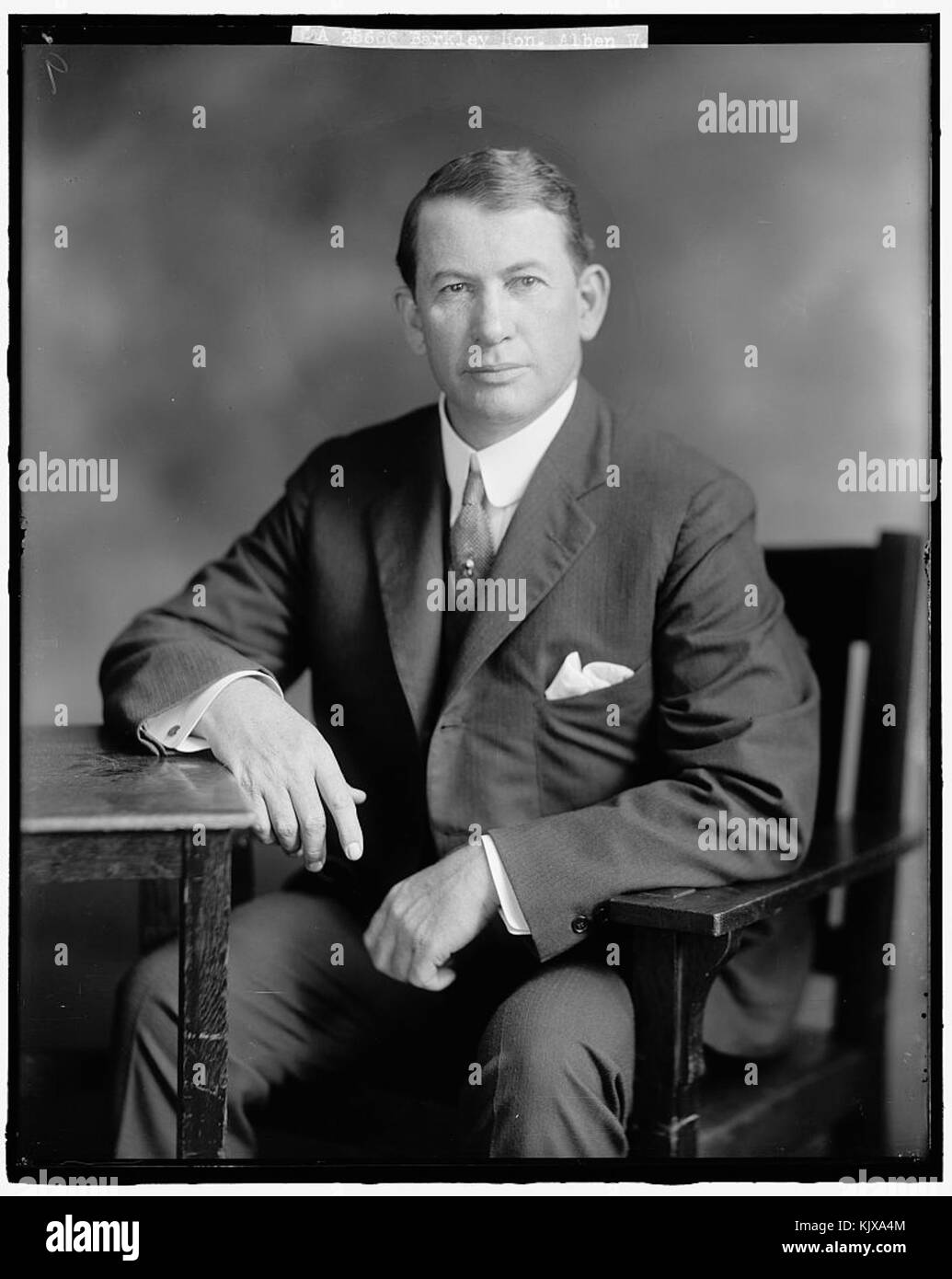 This photograph shows Alben Barkley, an American politician, seated at ...