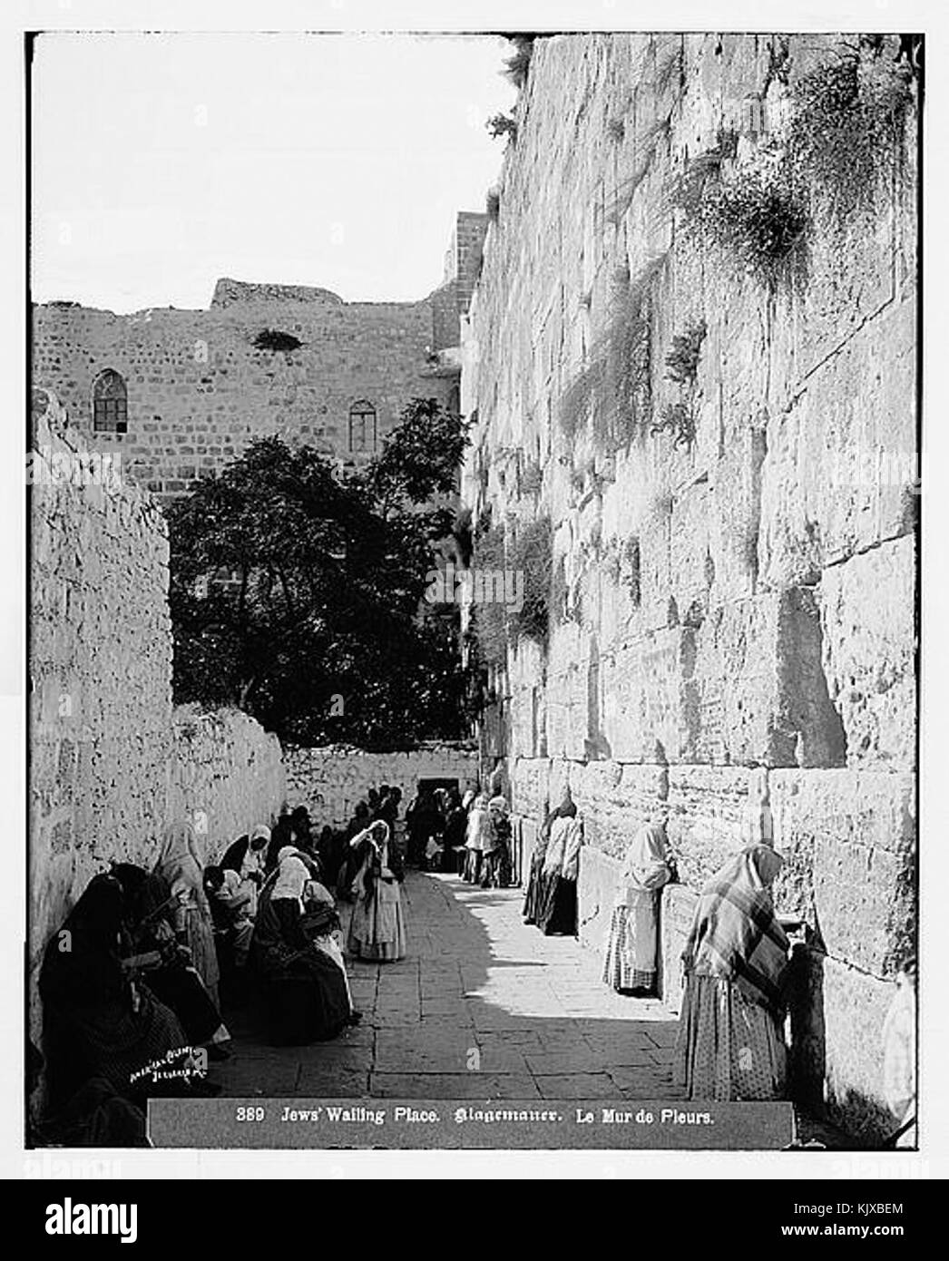 This historical photograph captures the Wailing Wall in Jerusalem, a ...