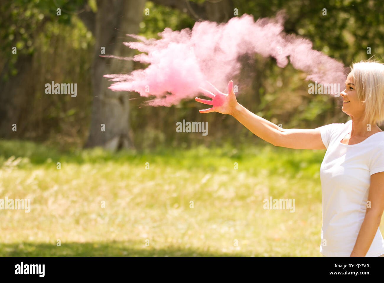 Young funky couple playing with colourful water paint powder on the ...
