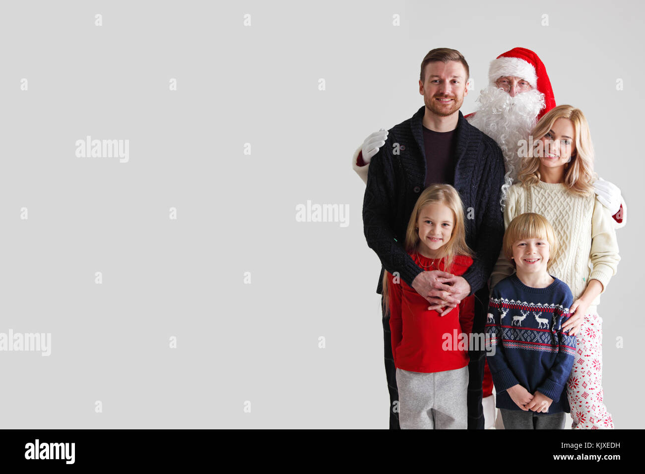 Christmas portrait of happy smiling family with two children and Santa ...