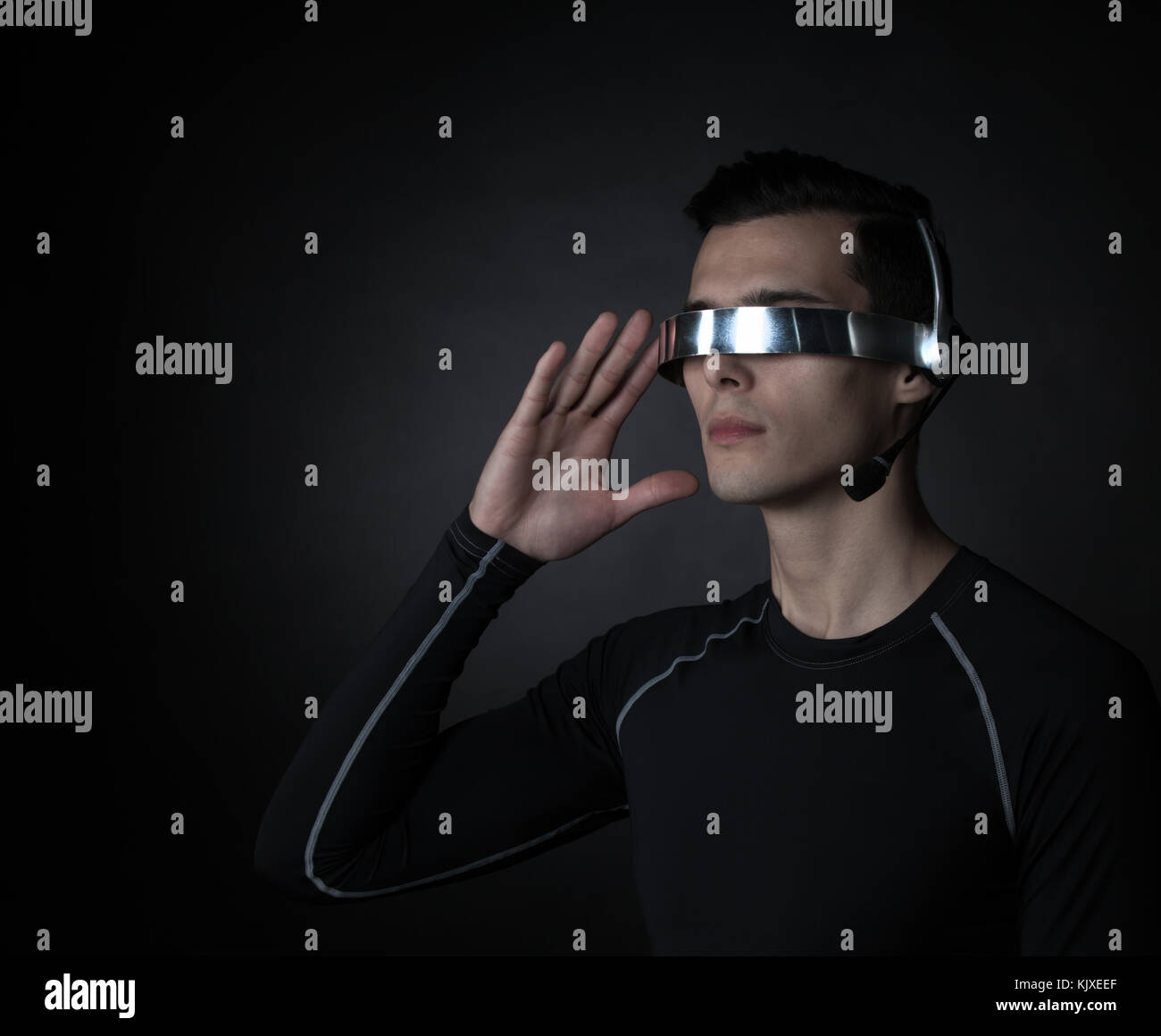 Man using futuristic VR goggles headset with microphone Stock Photo - Alamy
