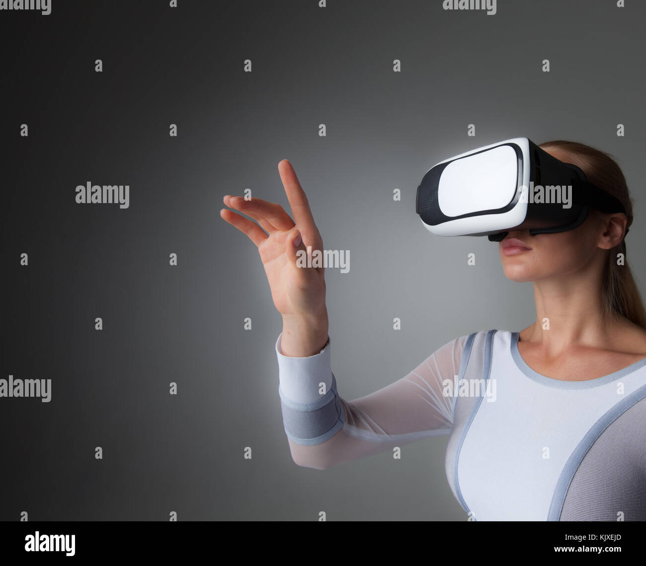 Young woman in white futuristic clothes with vr headset Stock Photo - Alamy