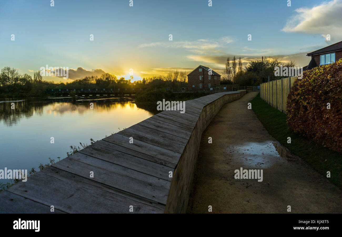 A view of a sunset taken taken from the banks of the River Mersey at ...