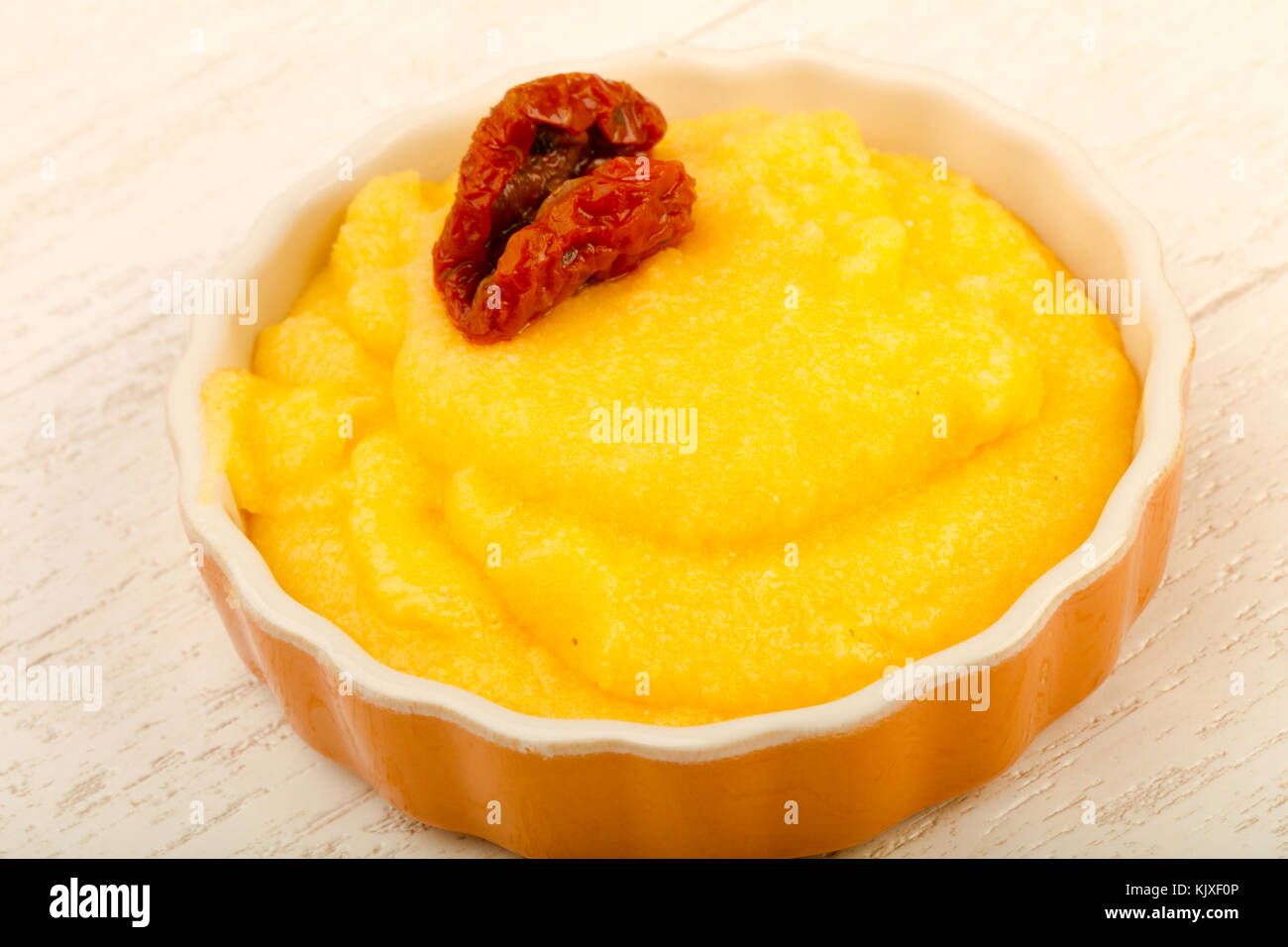 Polenta with dry tomato Stock Photo - Alamy