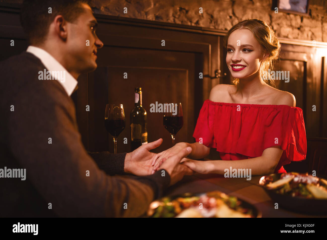 Beautiful love couple in restaurant, romantic evening. Elegant woman in ...