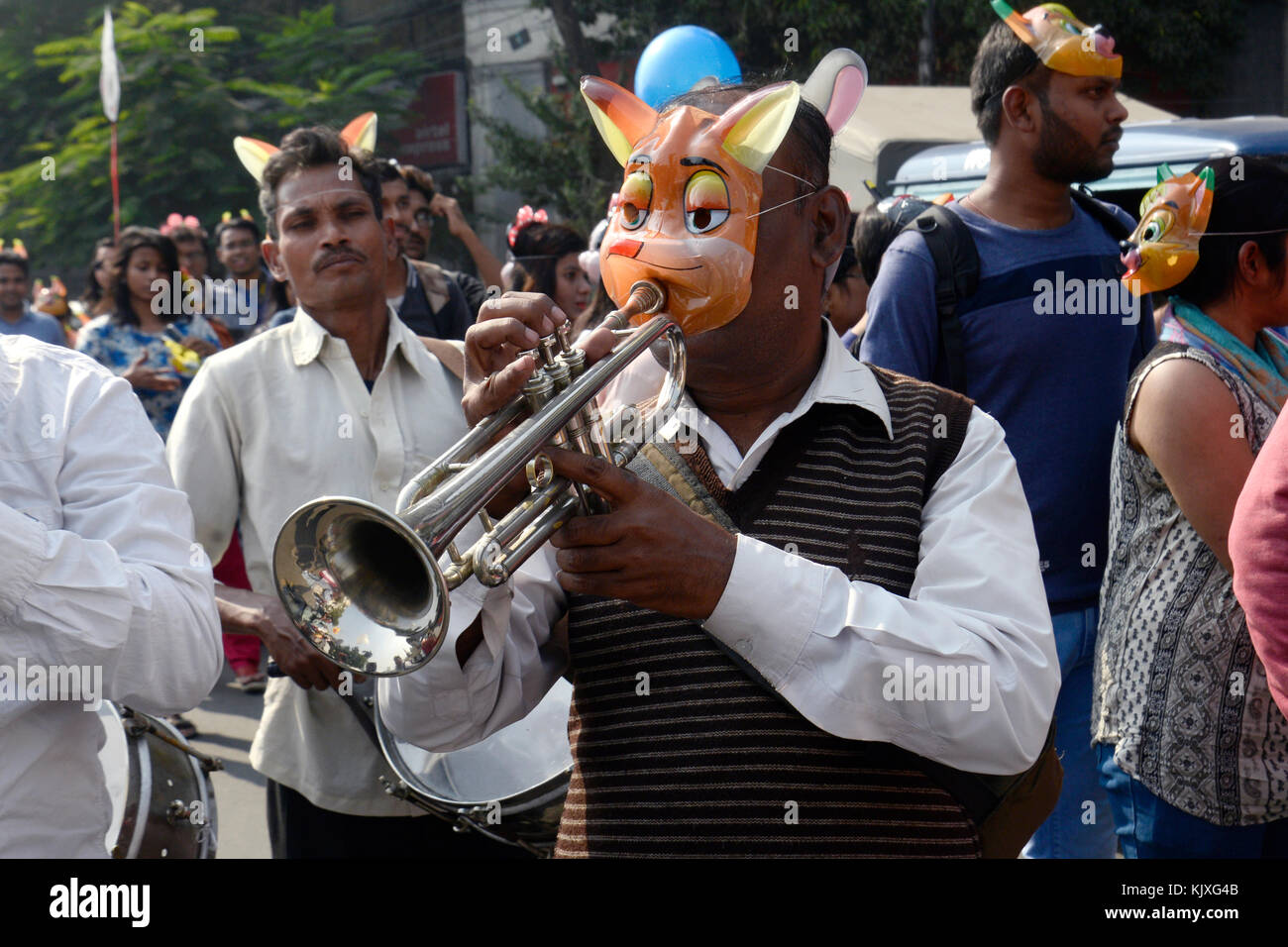 Kolkata, India. 26th Nov, 2017. A trumpet player wears an animal musk ...