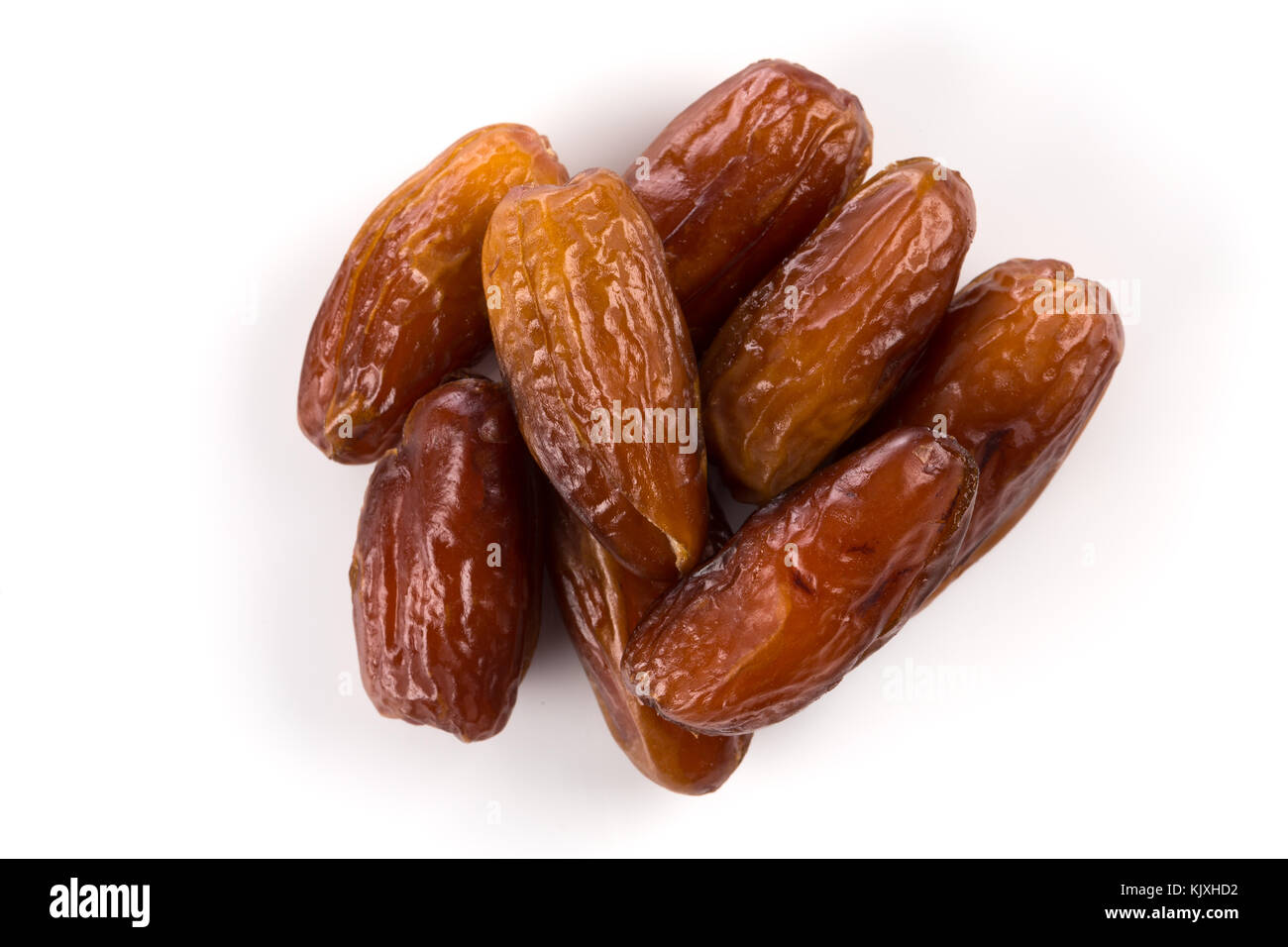 pile of dates fruits isolated on a white background Stock Photo - Alamy
