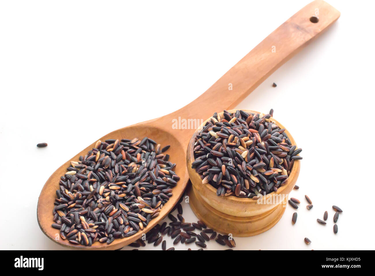 Rice berry or uncooked brown rice in wood bowl on white background ...