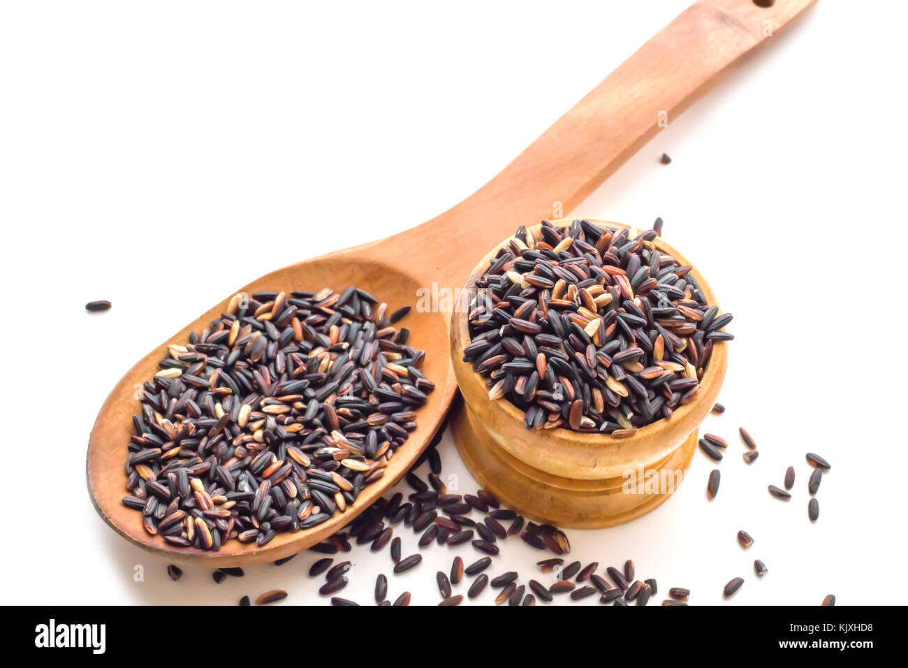 Rice berry or uncooked brown rice in wood bowl on white background ...