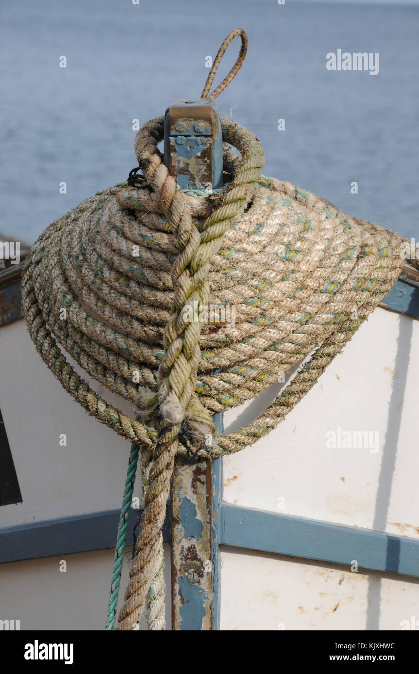 Coiled bow rope on small fishing boat Stock Photo - Alamy