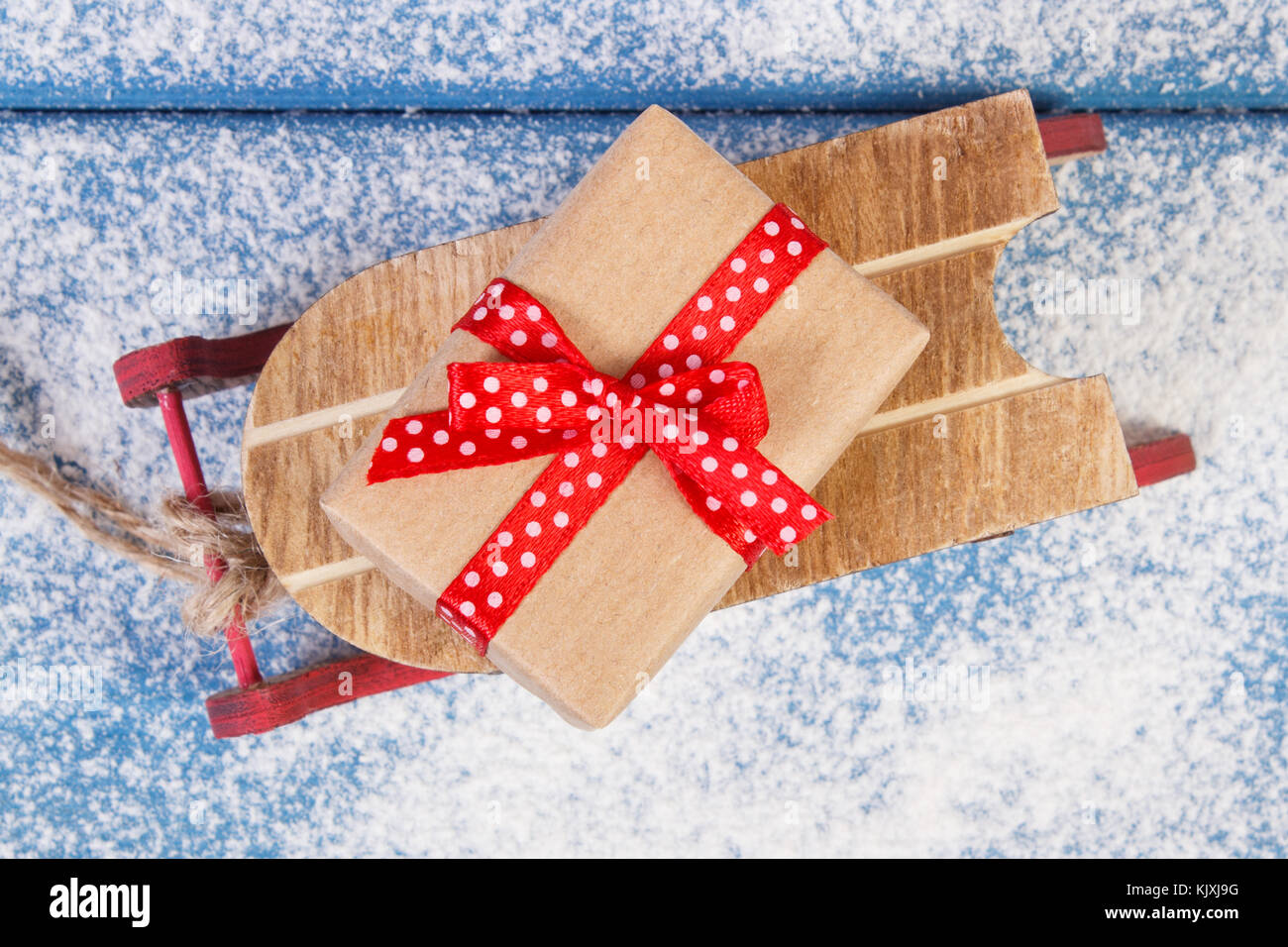 Wooden sled and wrapped gift with ribbons for Christmas, Valentine ...