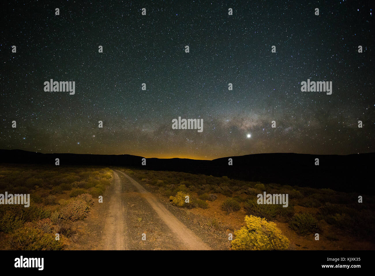 Wide angle view of a two track road in the Karoo at night with the ...