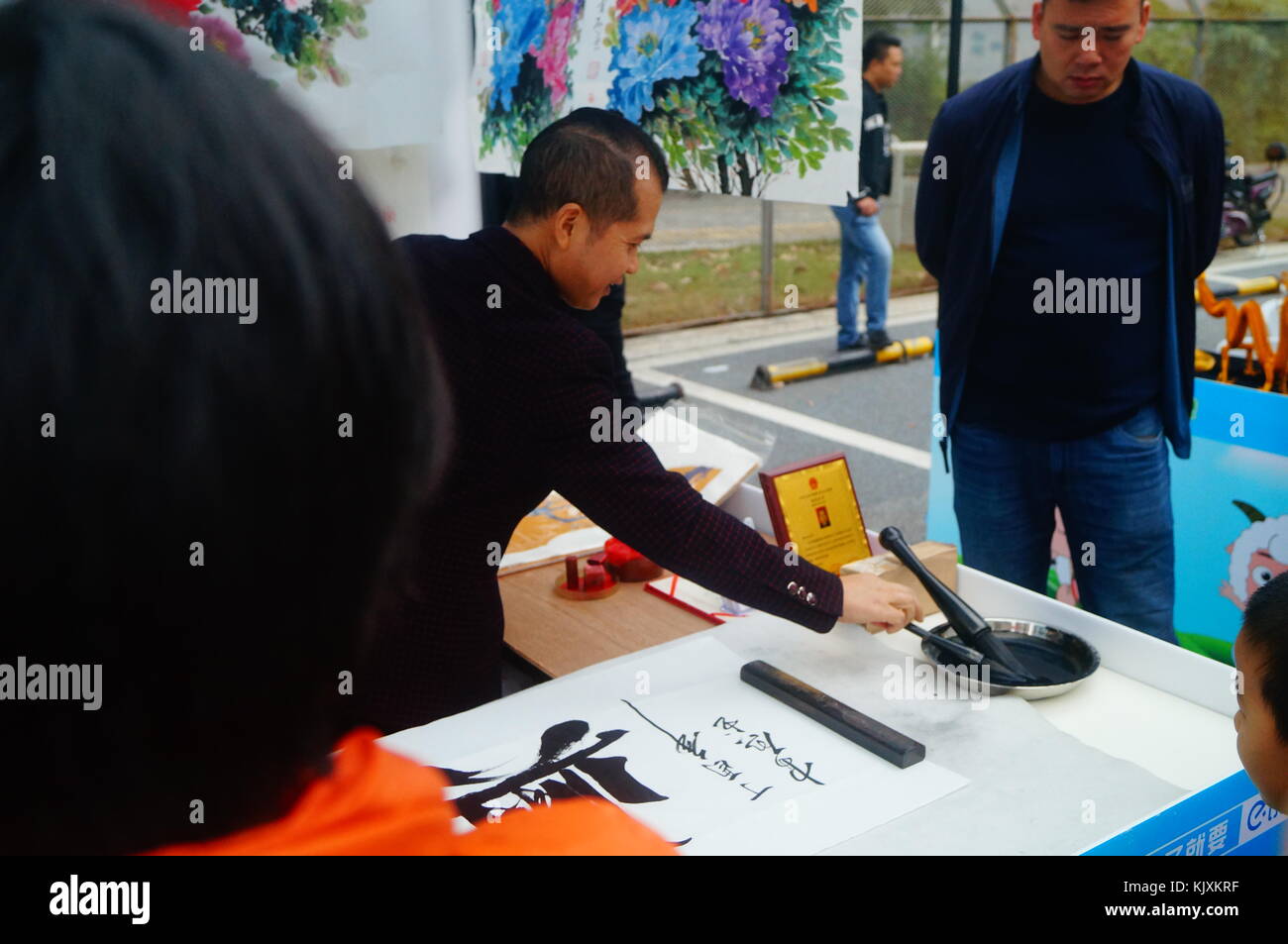 A Chinese calligraphy artist is selling his own calligraphy paintings ...