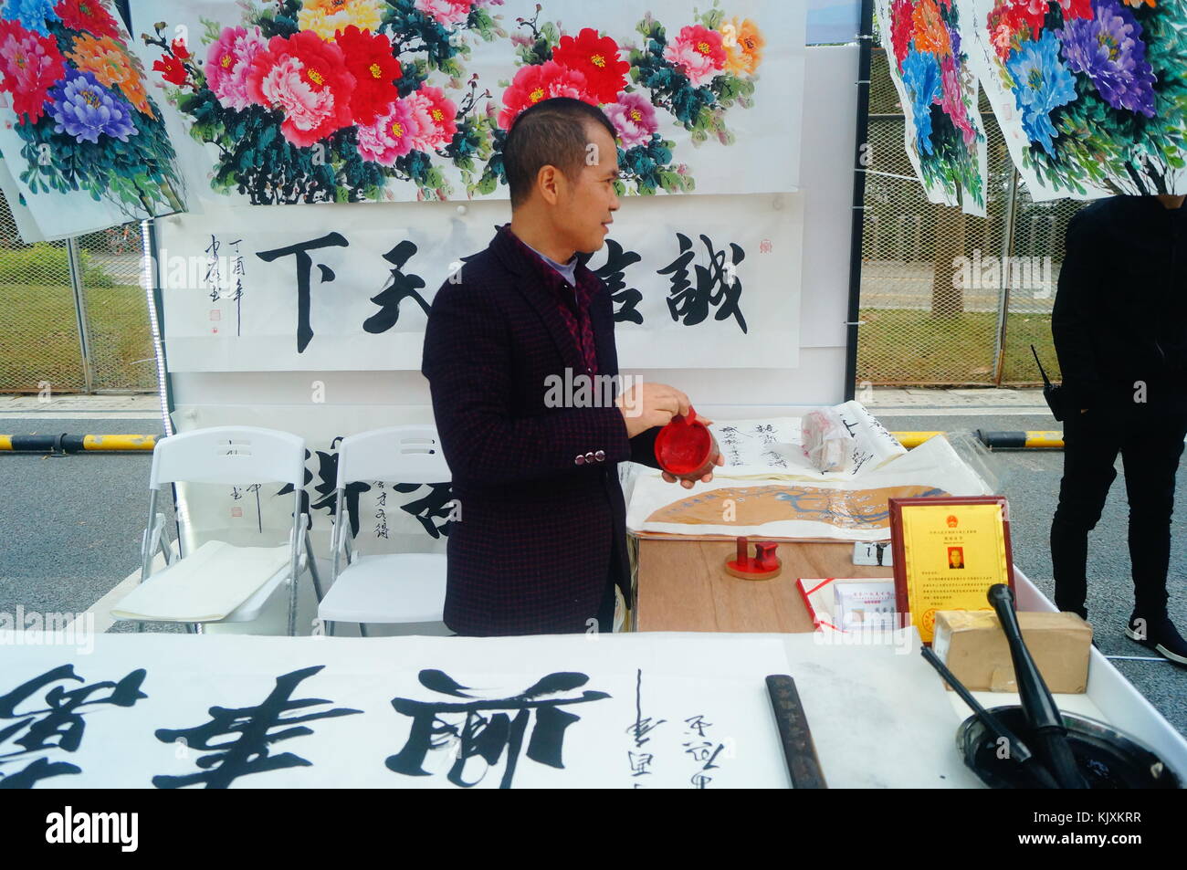 A Chinese calligraphy artist is selling his own calligraphy paintings ...