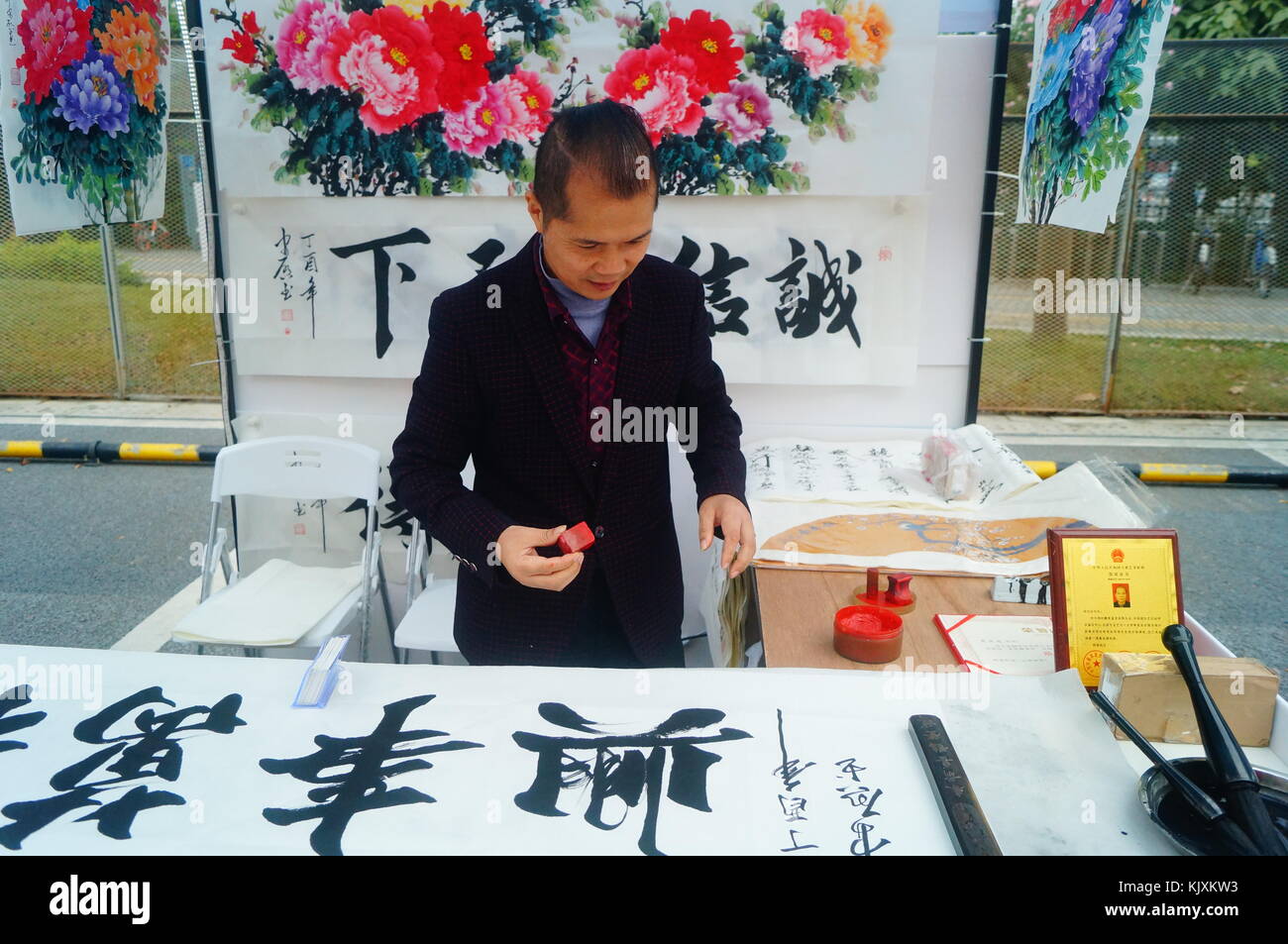 A Chinese calligraphy artist is selling his own calligraphy paintings ...