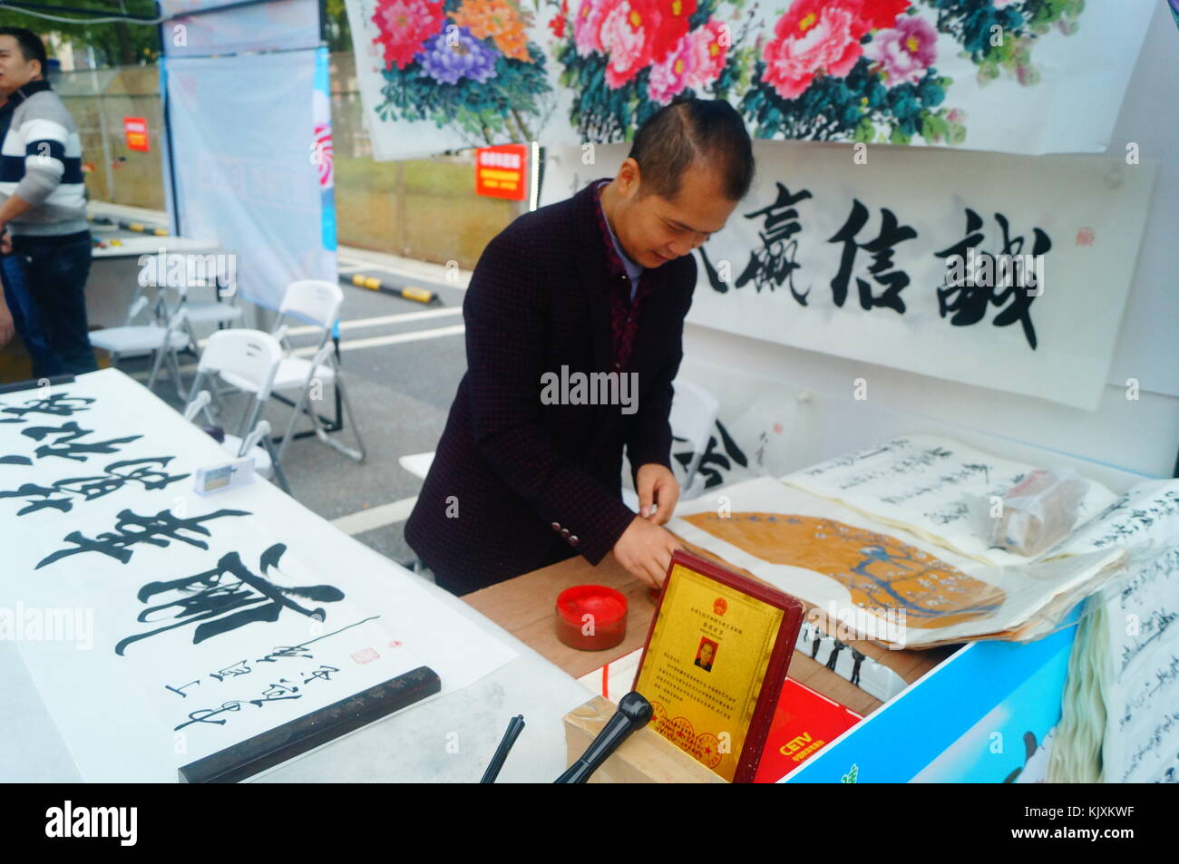 A Chinese calligraphy artist is selling his own calligraphy paintings ...