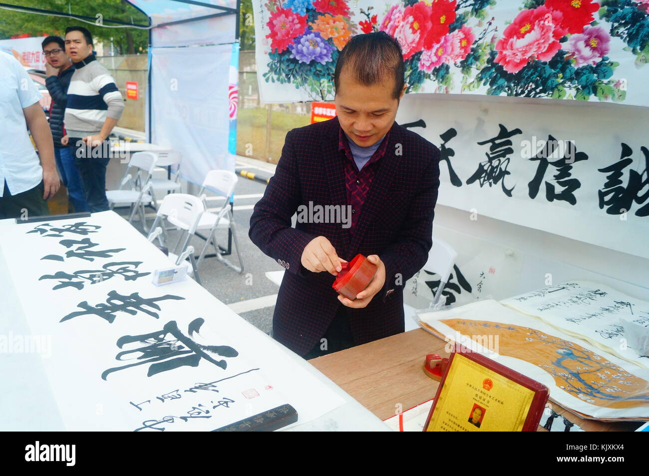 A Chinese calligraphy artist is selling his own calligraphy paintings ...