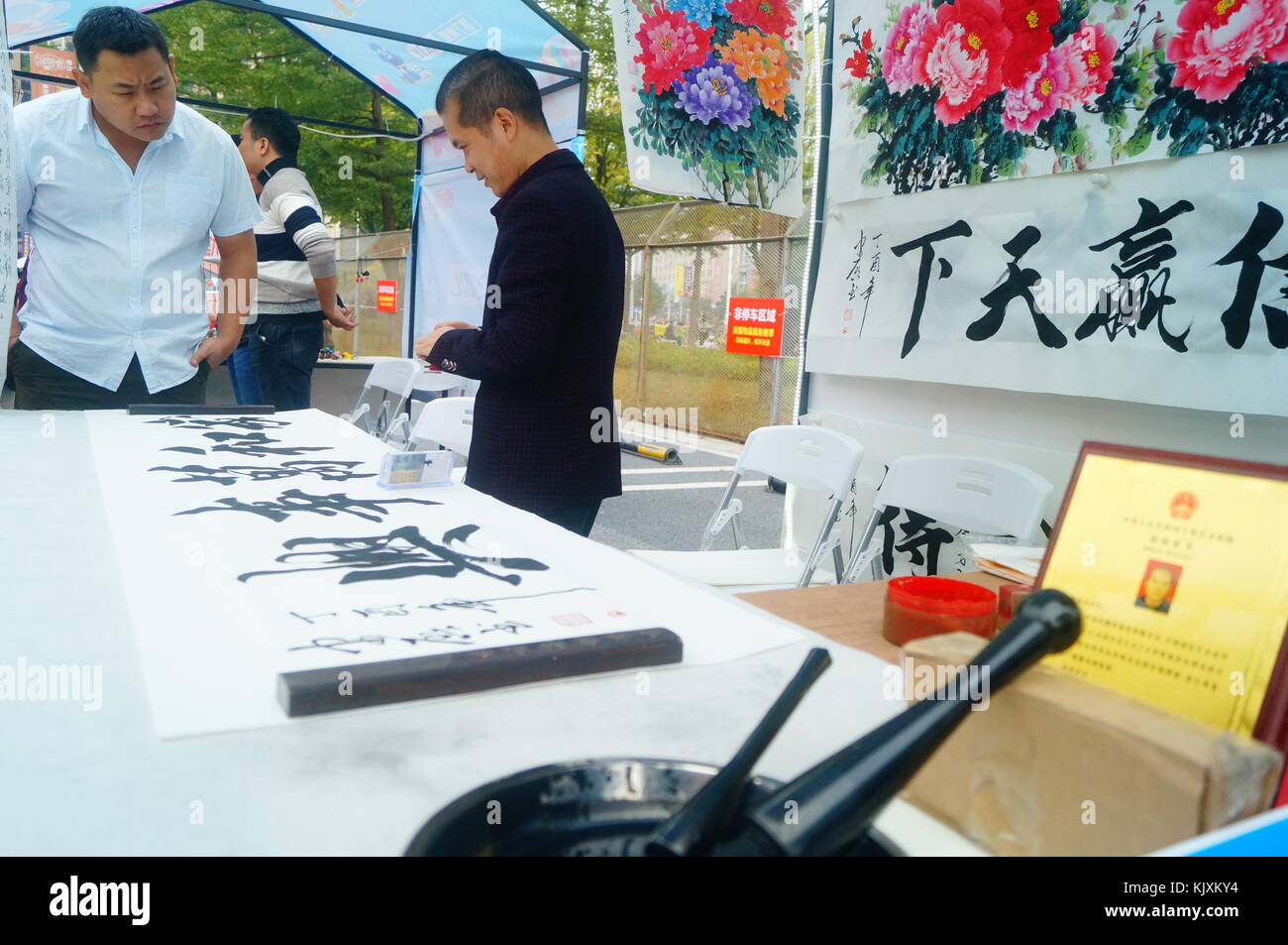A Chinese calligraphy artist is selling his own calligraphy paintings ...