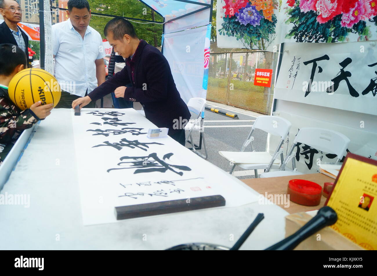A Chinese calligraphy artist is selling his own calligraphy paintings ...