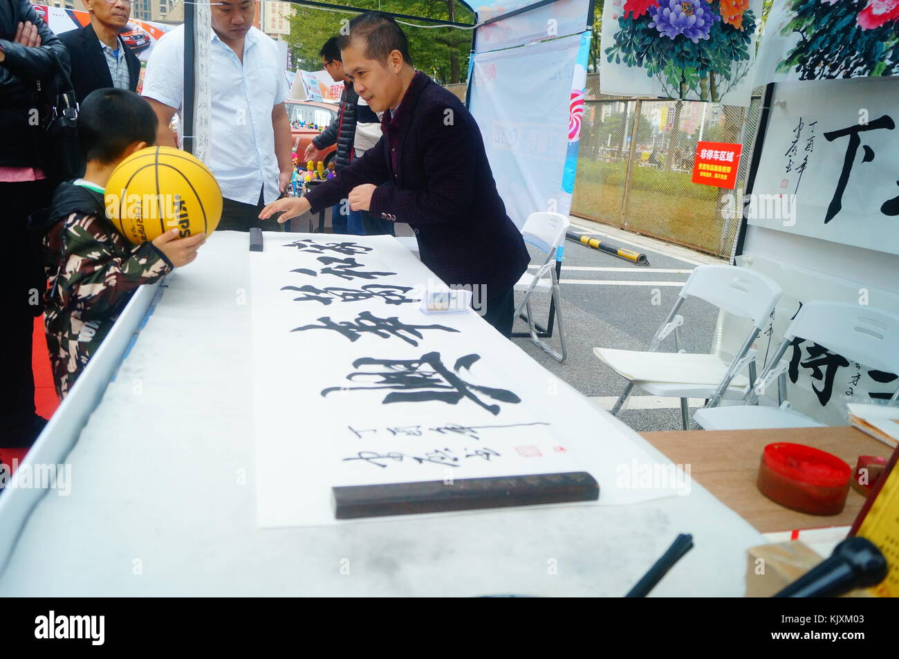 A Chinese calligraphy artist is selling his own calligraphy paintings ...