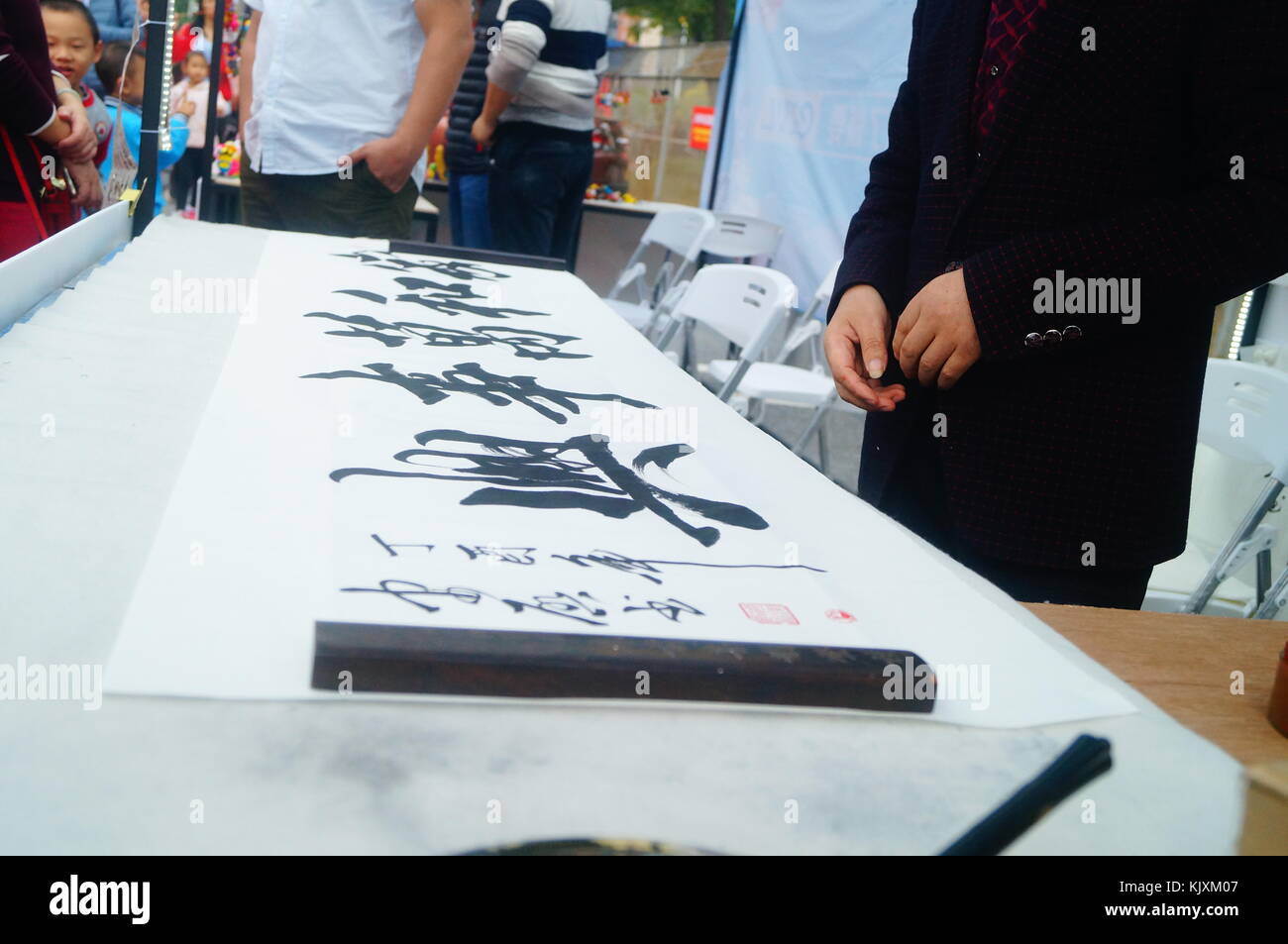 A Chinese calligraphy artist is selling his own calligraphy paintings ...