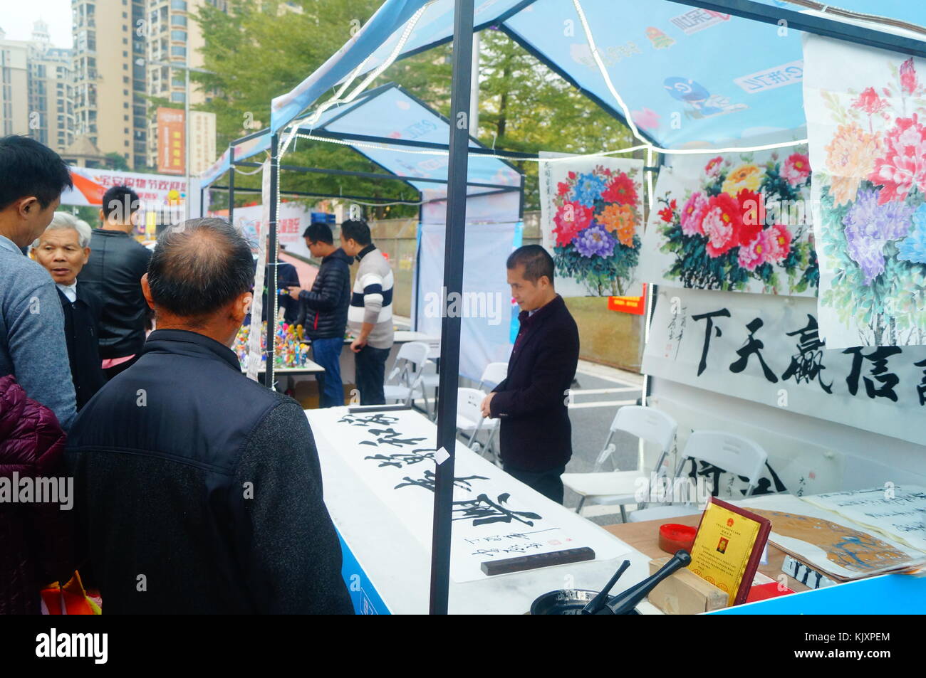A Chinese calligraphy artist is selling his own calligraphy paintings ...