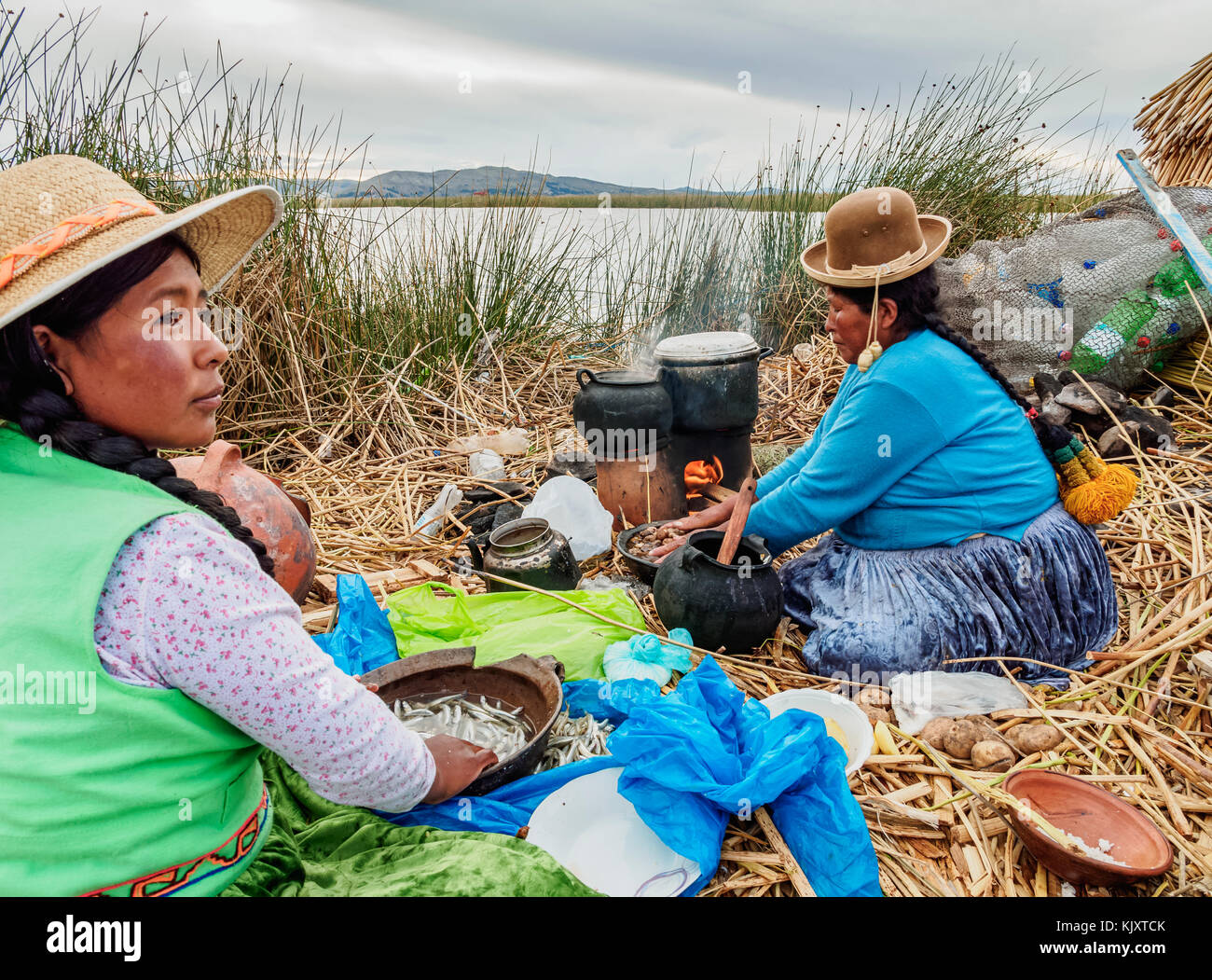 Native Uro Family preparing a meal, Uros Floating Islands, Lake ...