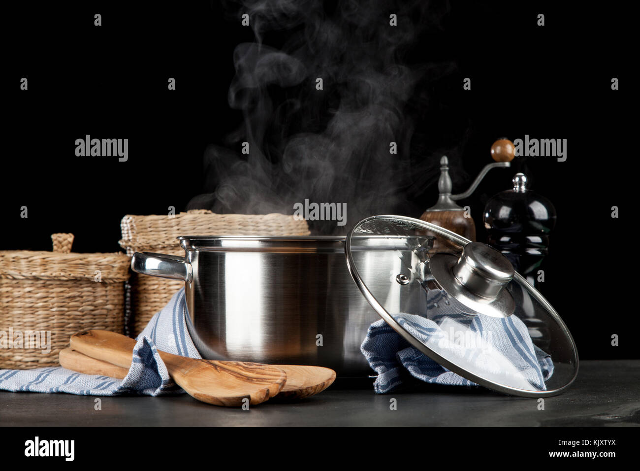 Steaming pot on black background Stock Photo - Alamy