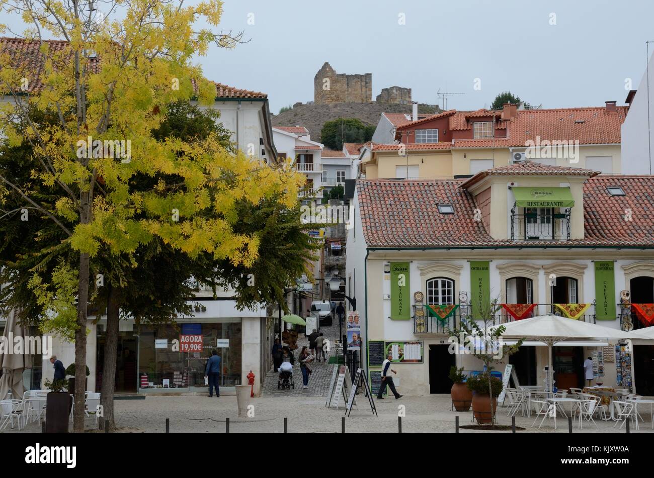 Cobbled street in the medieval town of Alcobaca leading to the castle ...
