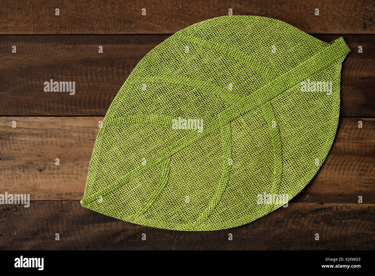 leaf shape mat on wooden table. use for display product. mock up Stock ...