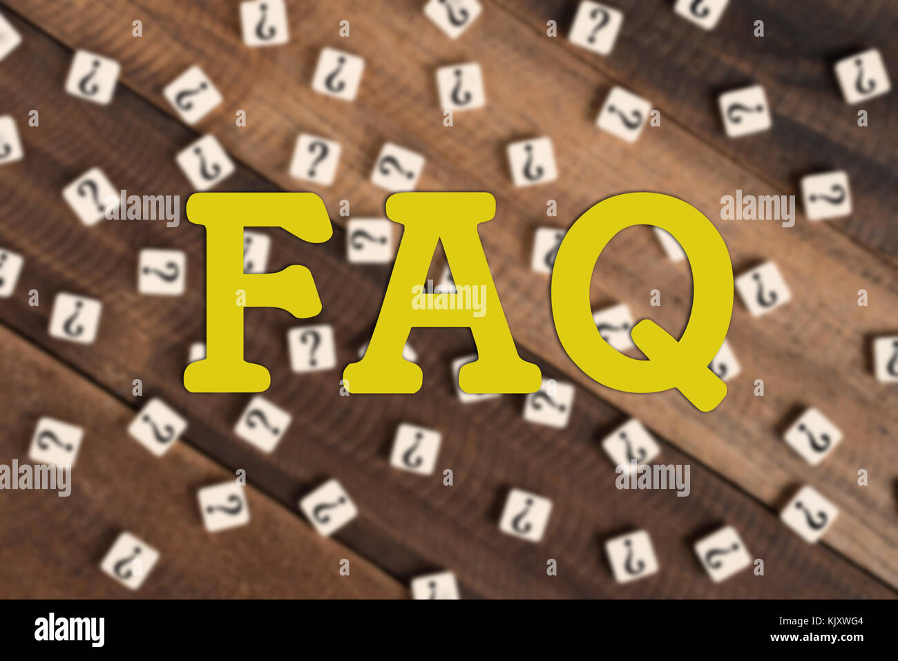 frequently asked question FAQ with question mark tiles. FAQ word on ...