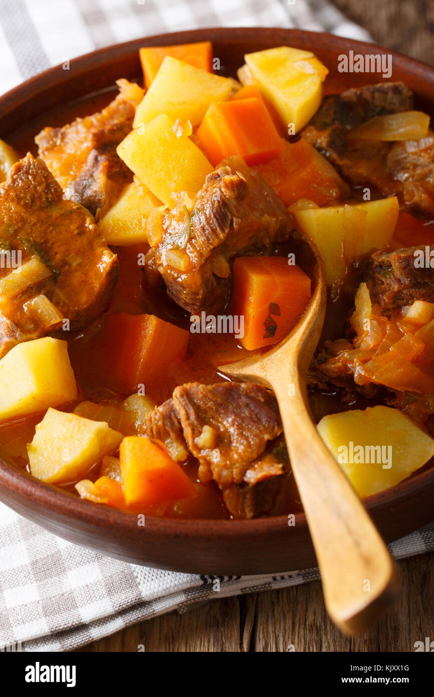 thick stewed estofado with beef and vegetables close-up in a bowl ...