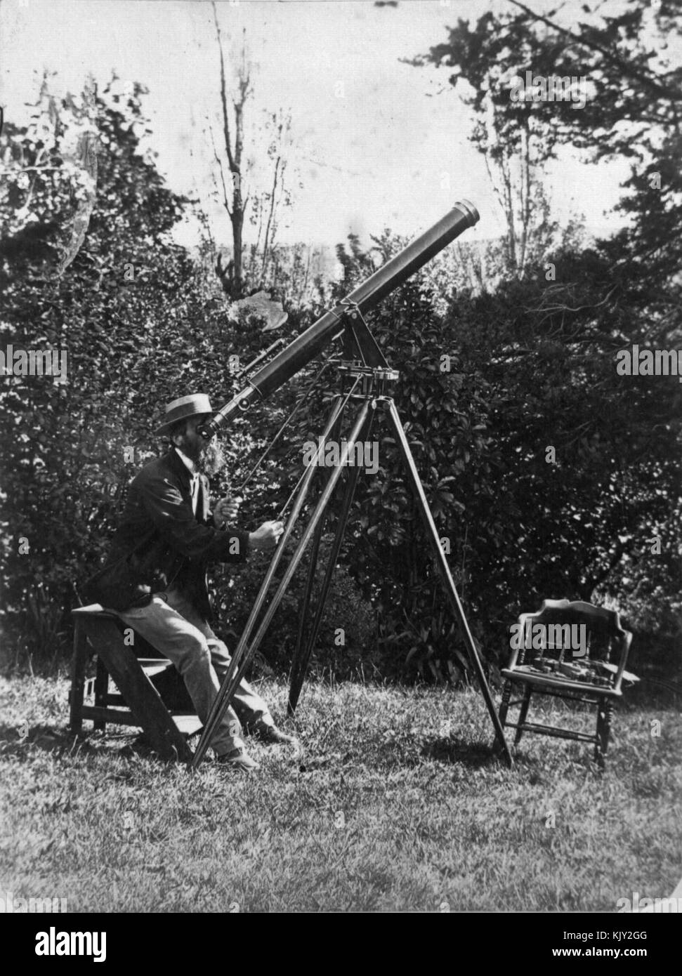Arthur Samuel Atkinson looking through a telescope Stock Photo - Alamy